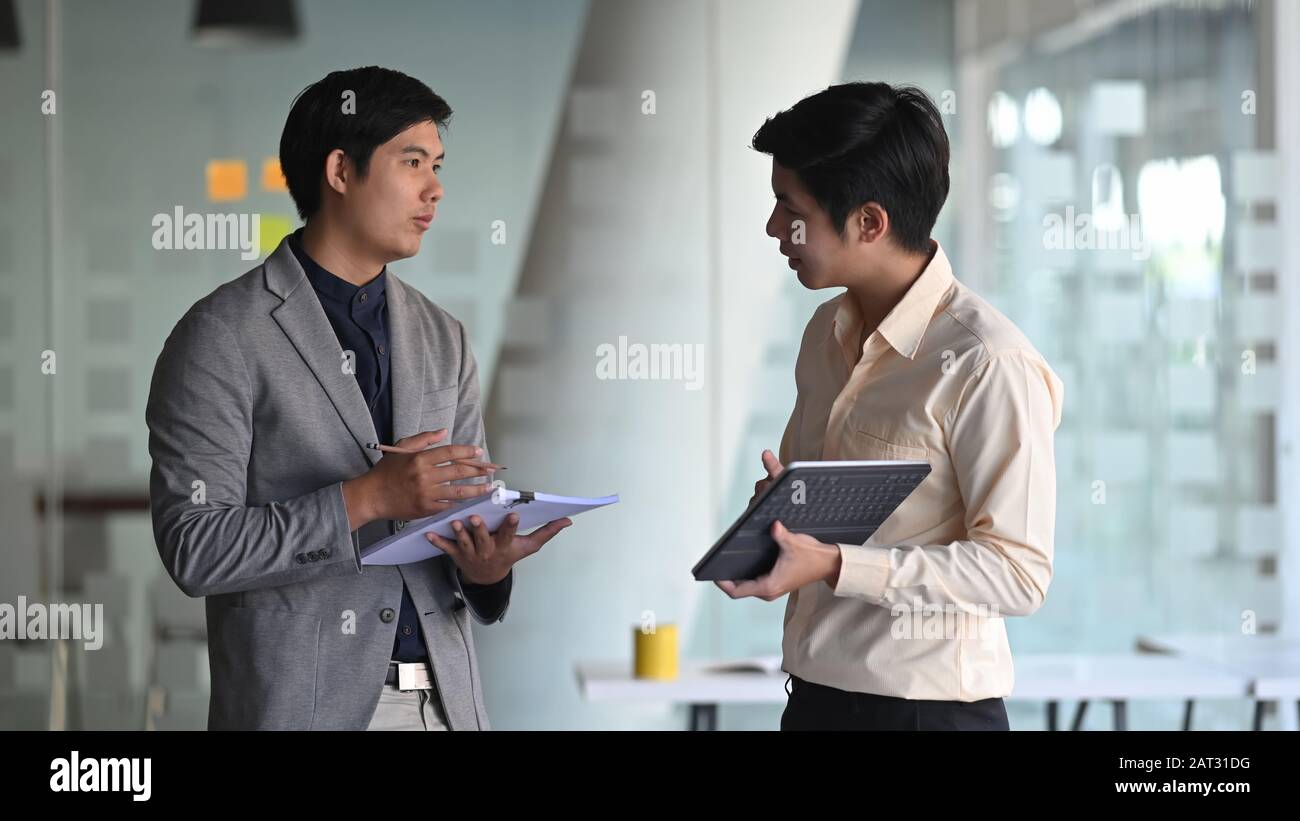 Photo of young business consulting man while talking/giving an advice ...