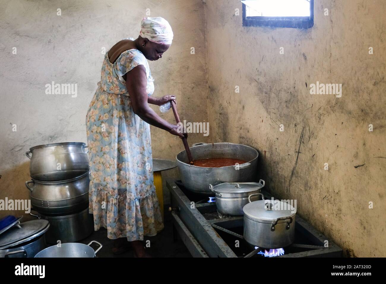 Cook prepares lunch in the school kitchen at the St. Martin Des Porres ...