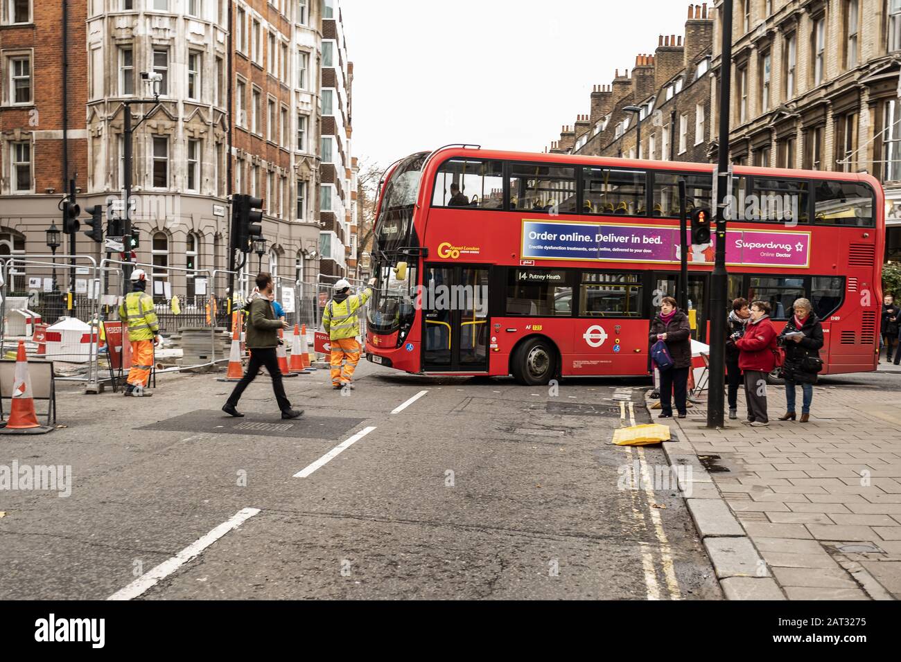 London / UK - Nov 28, 2019: maintenance worker helps to the double ...