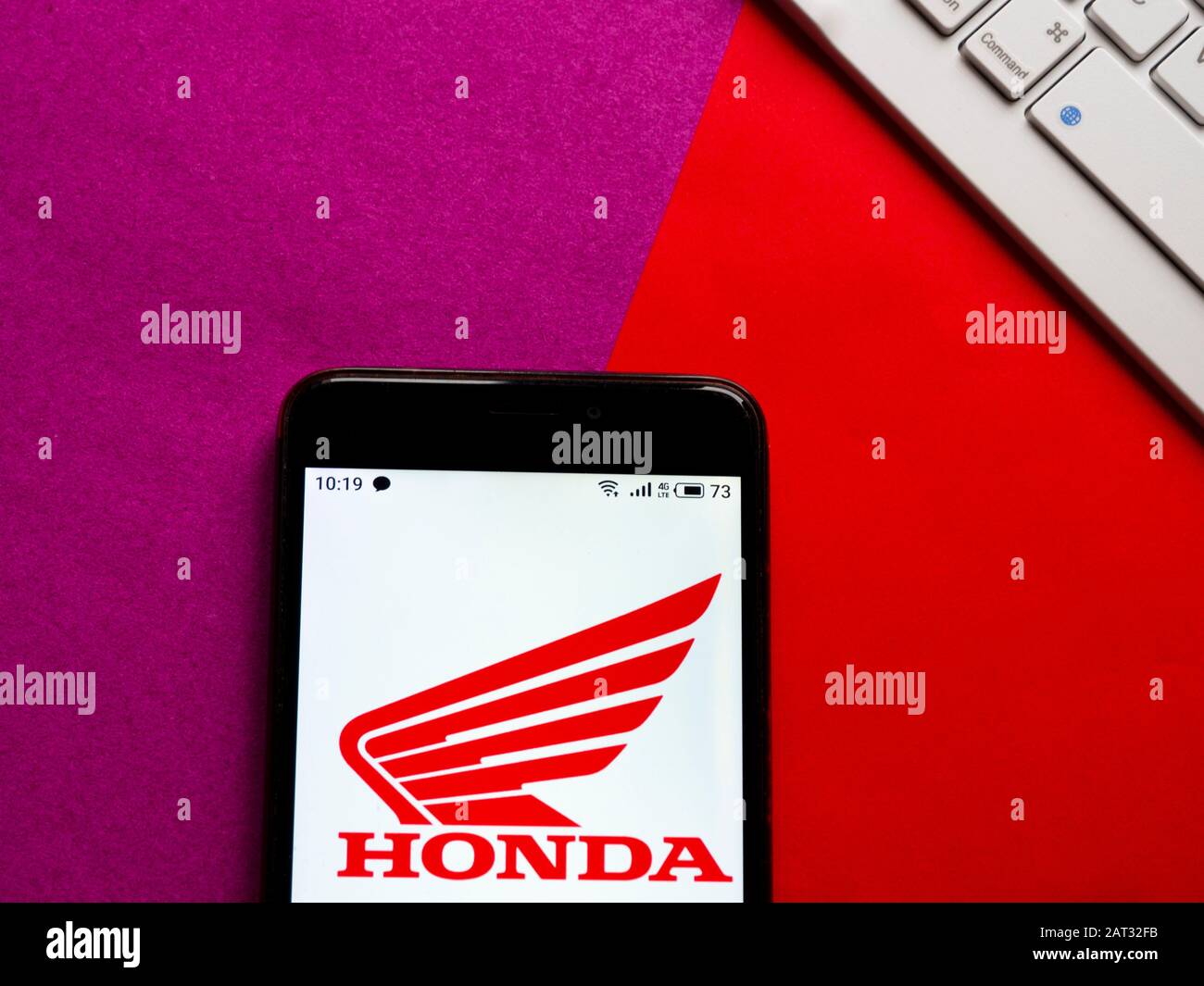 In this photo illustration a Honda logo seen displayed on a smartphone ...