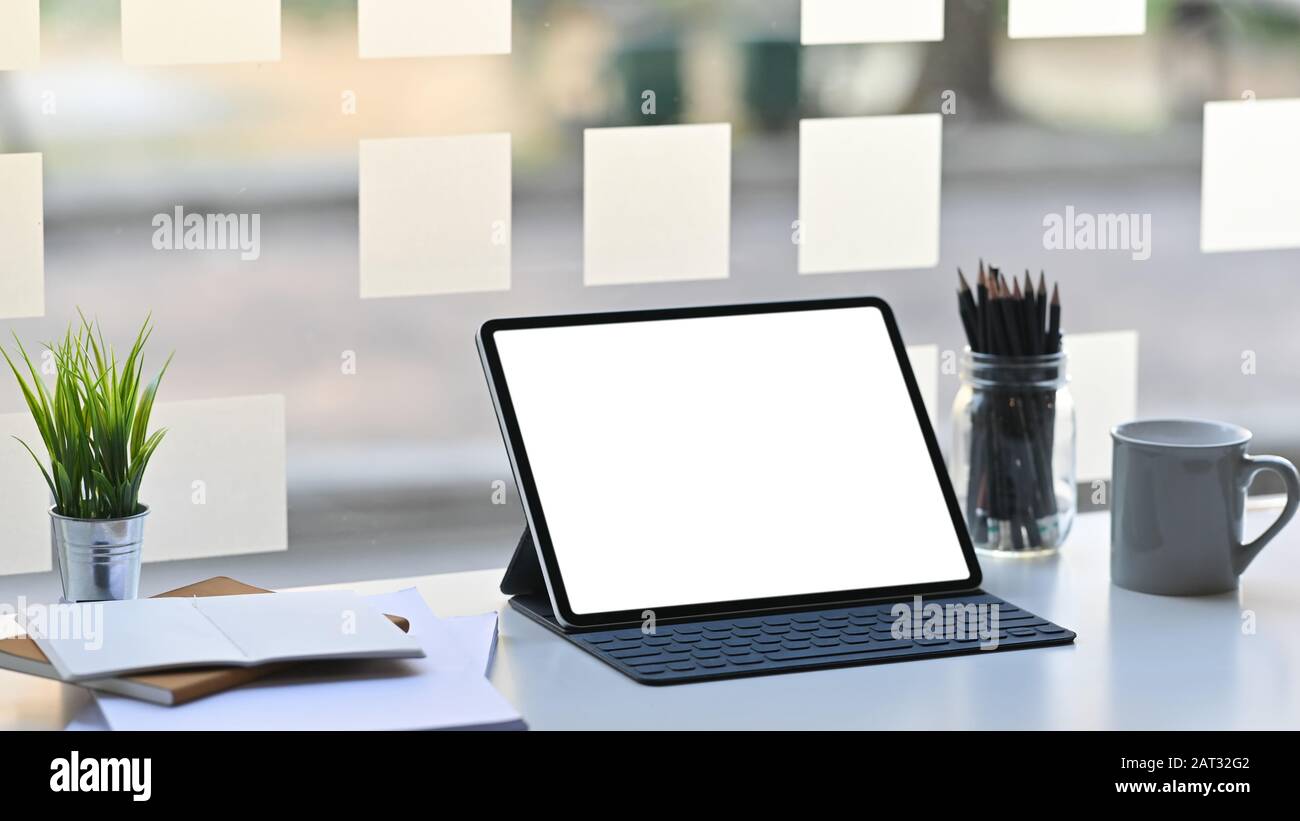 Blank screen computer tablet in a leather-case and keyboard is setting ...