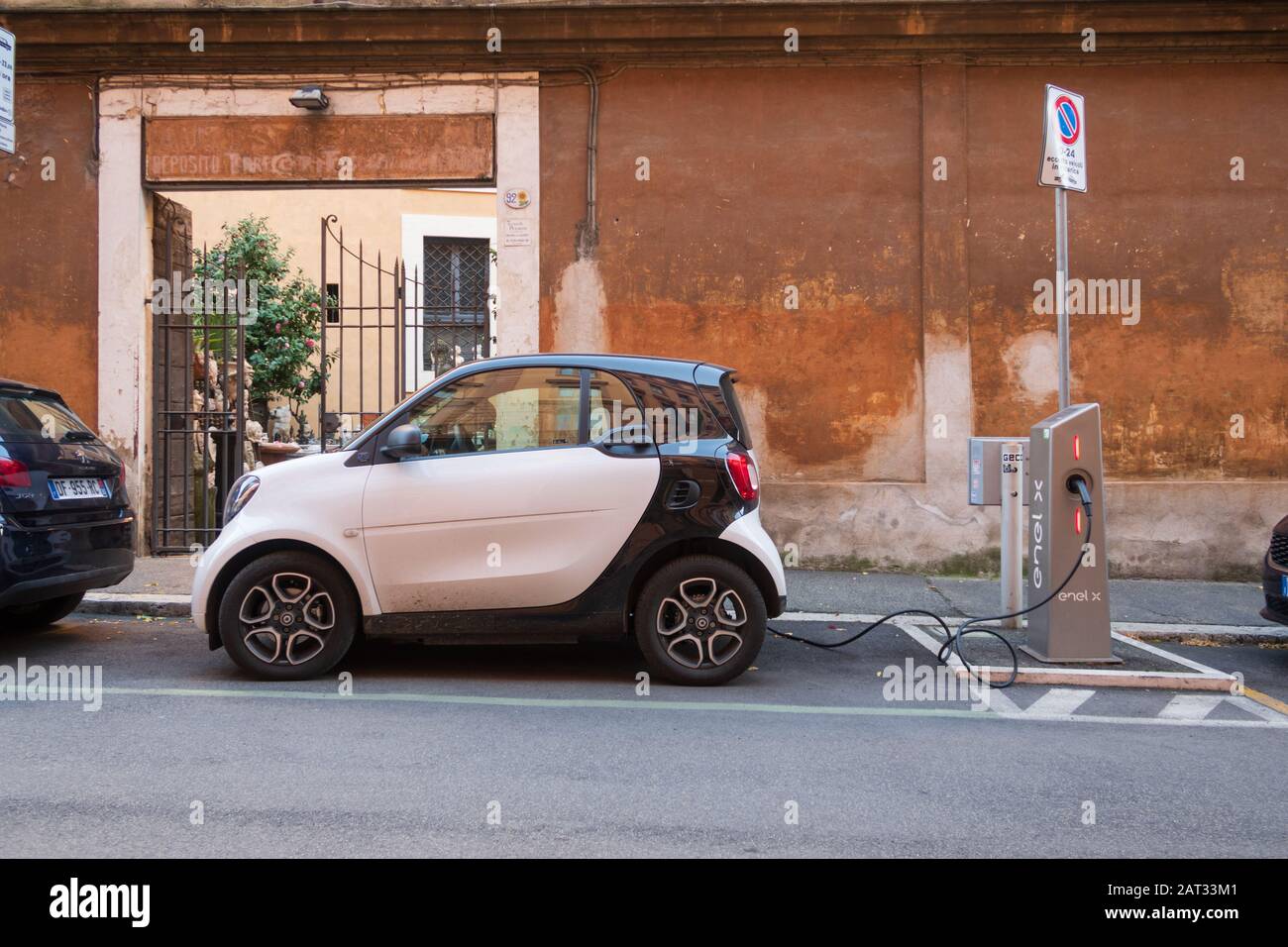 Rome, Italy - Dec 30, 2019: Smart electric car being charged from a ...