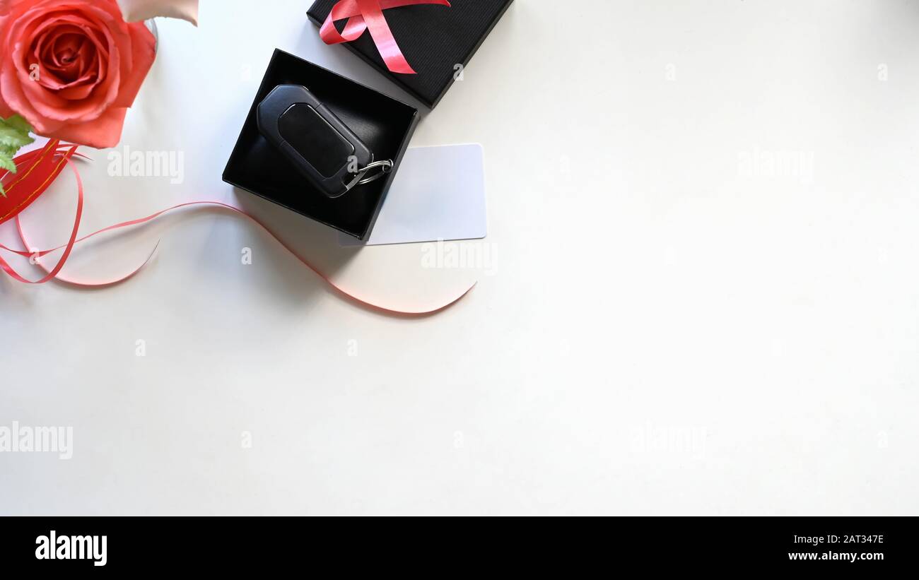 Top view Digital car key putting inside the black gift box with red ...