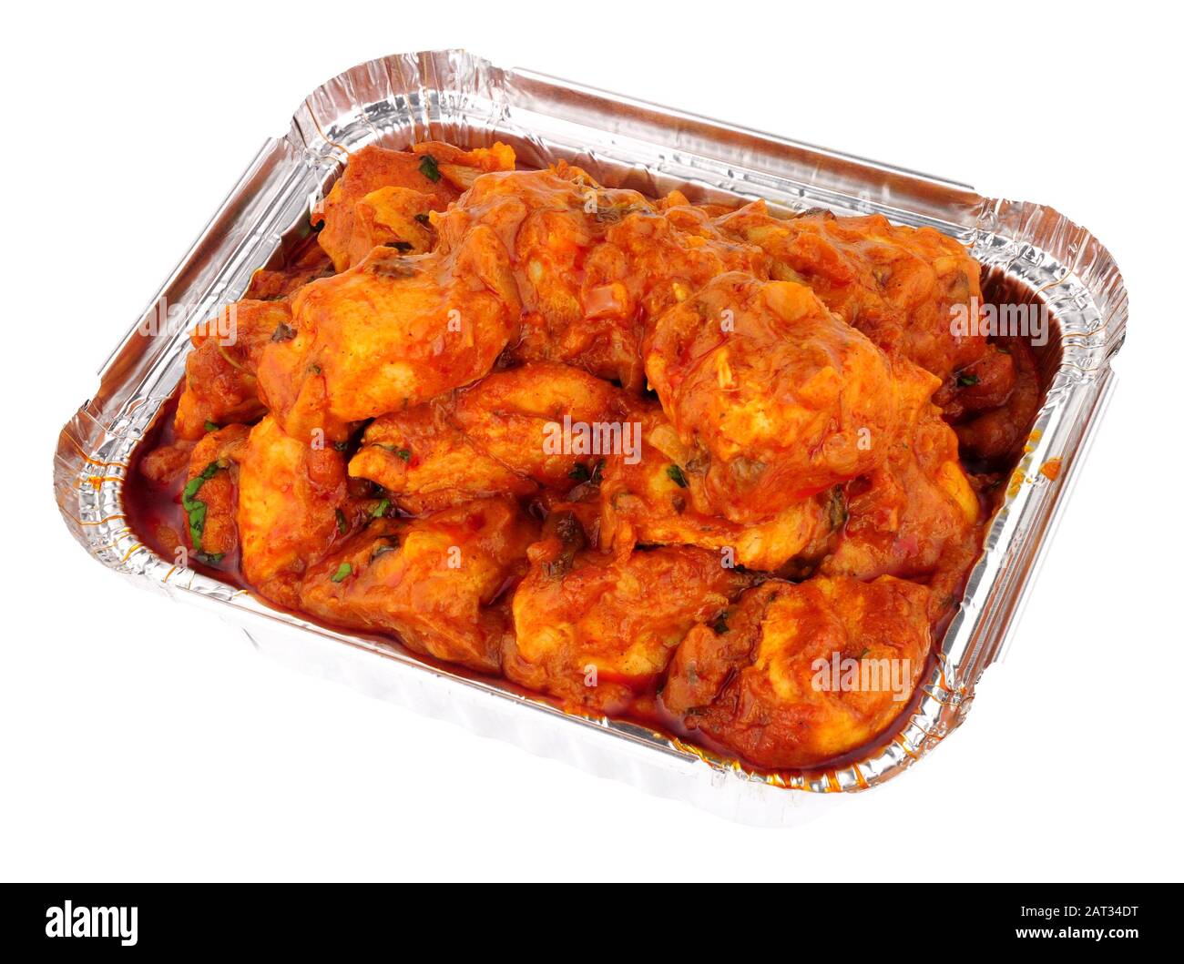 Spicy chicken curry take away in a foil container isolated on a white ...