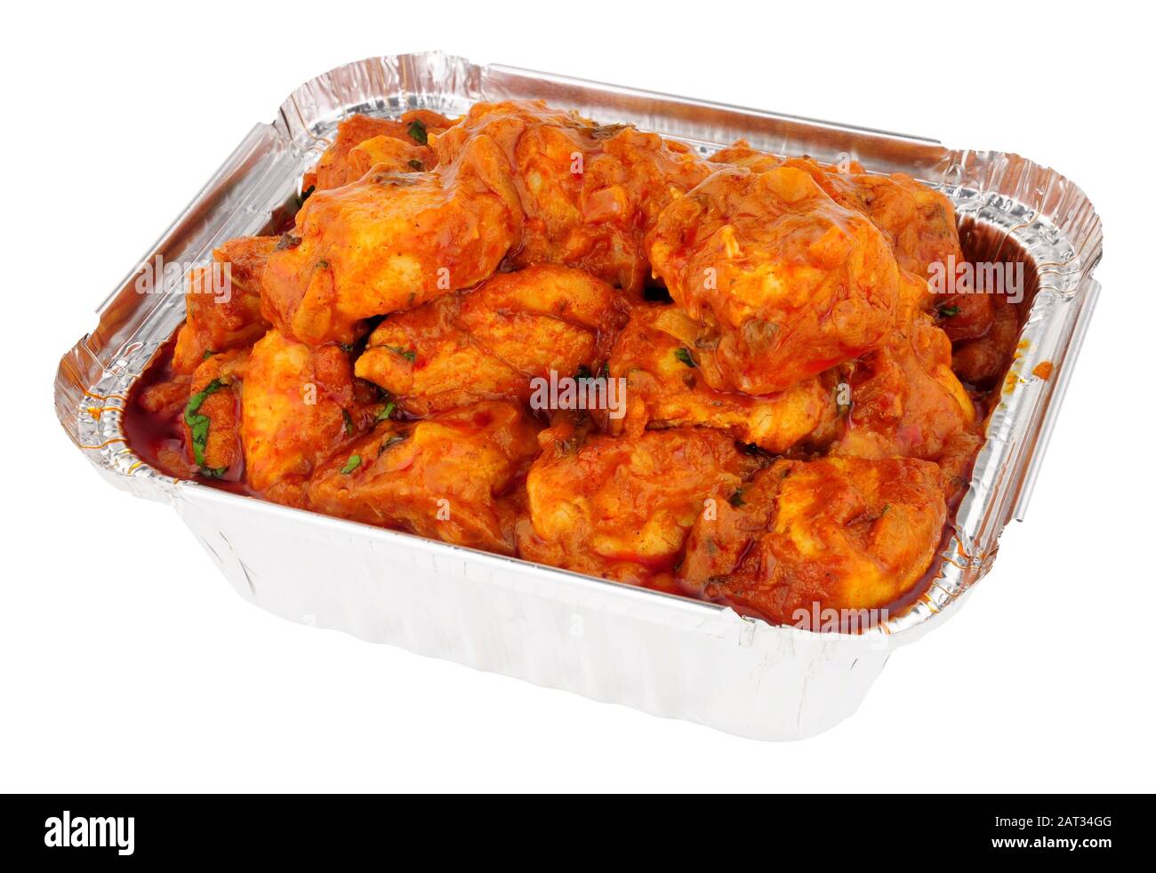 Spicy chicken curry take away in a foil container isolated on a white ...