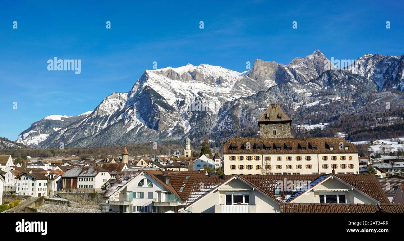 A winter mountain landscape view of idyllic historic city of Maienfeld ...