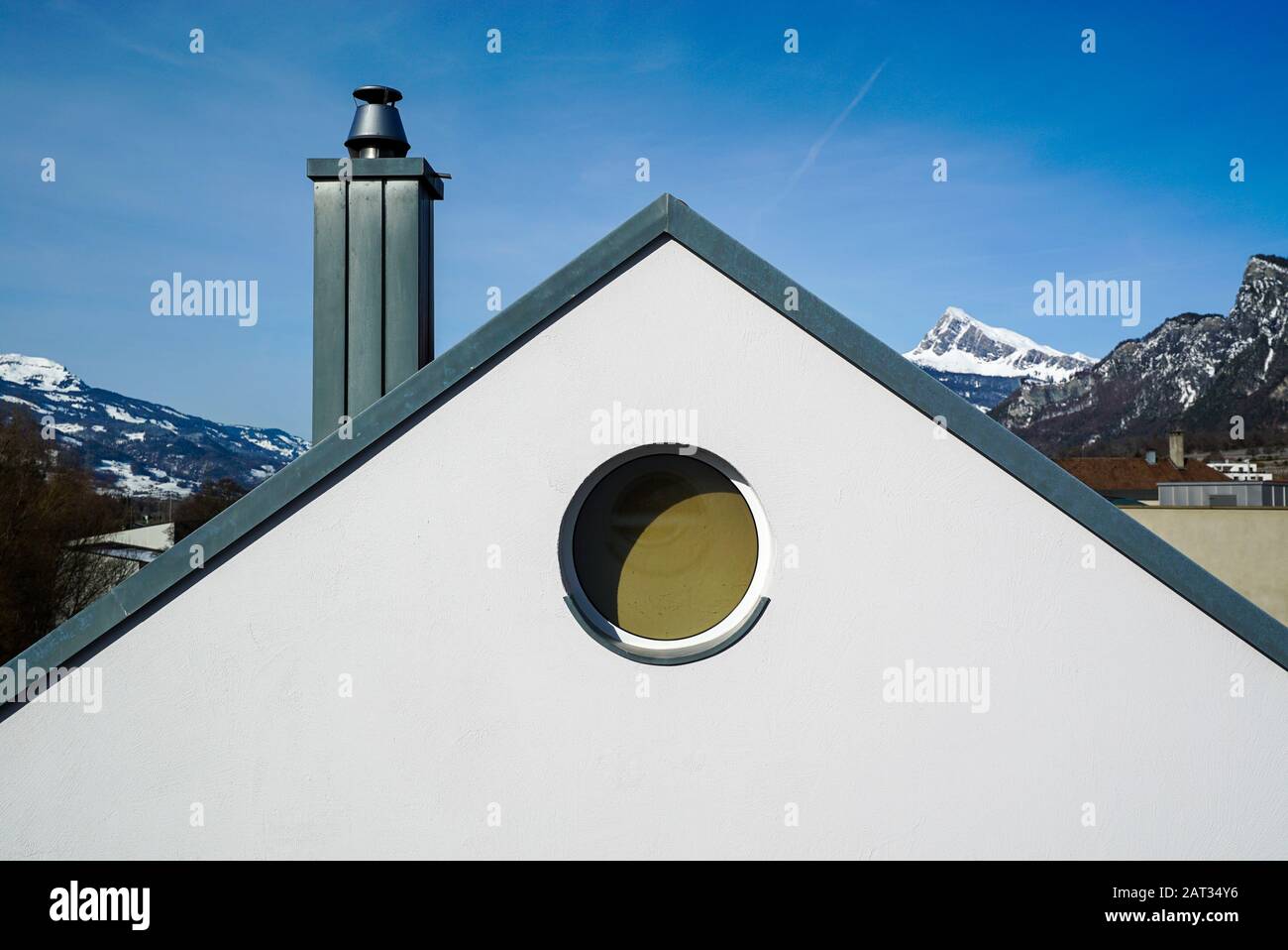 A close up view of a white house front with a gable roof and window and ...