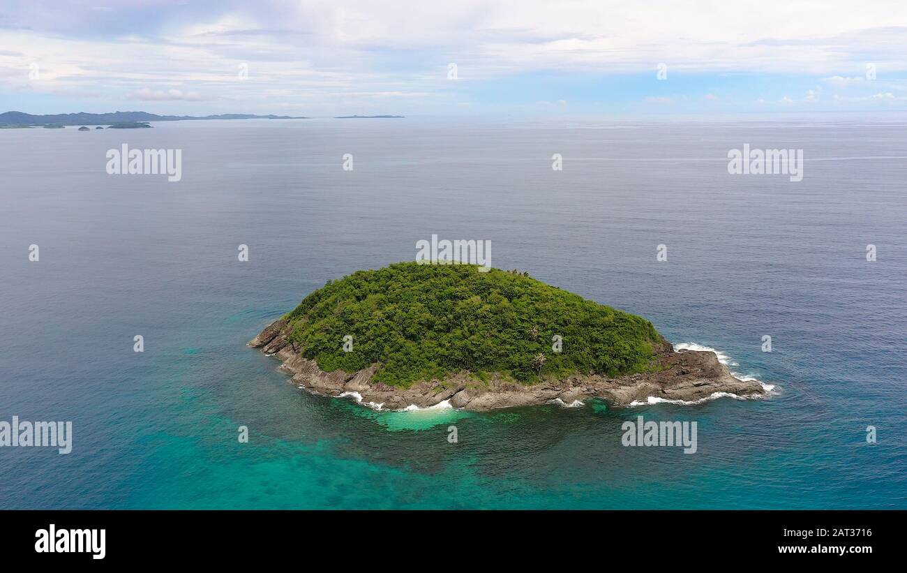 A small island covered in the jungle. Caramoan Islands, Camarines Sur ...