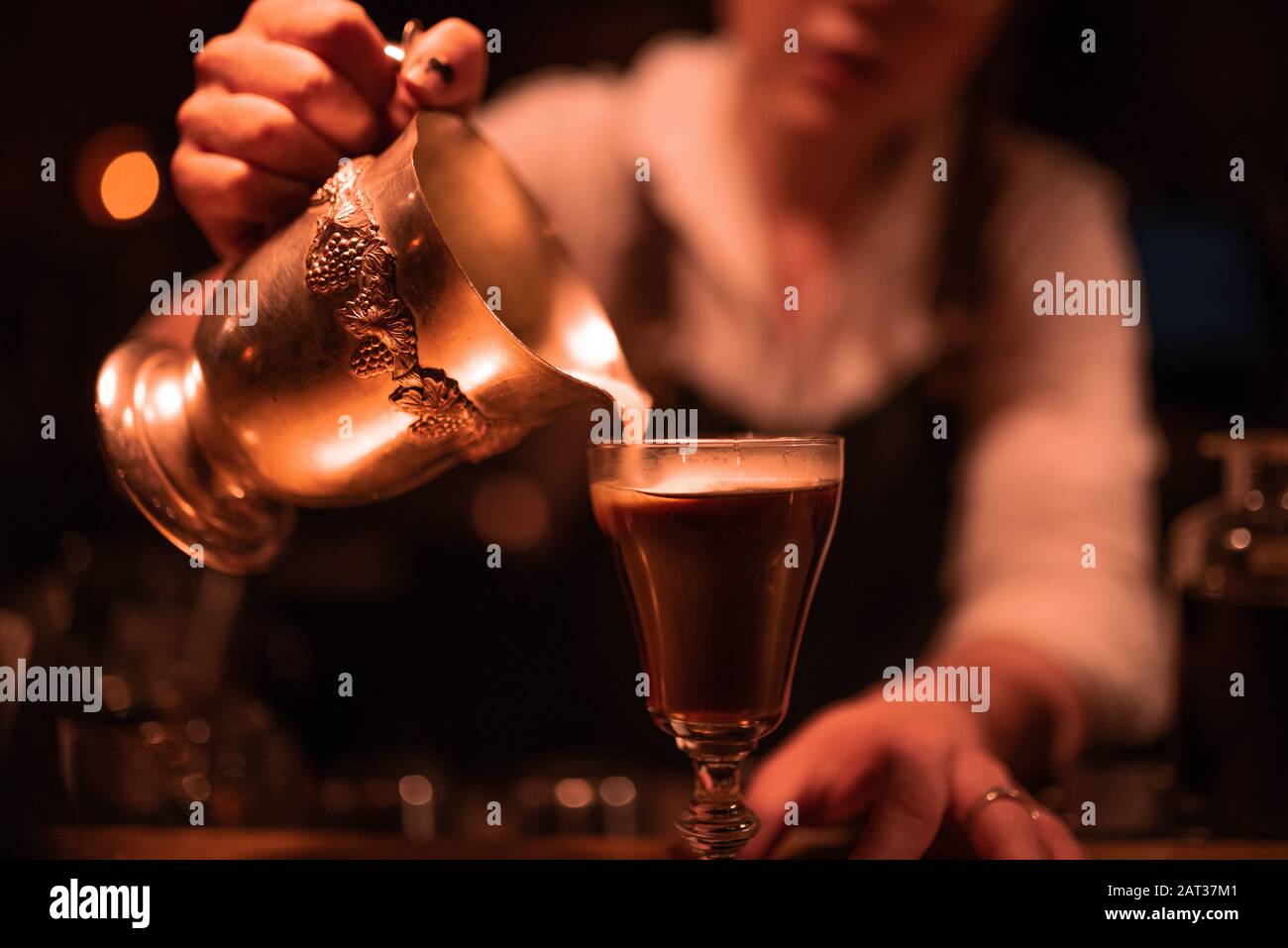 Bartender pouring cocktail Stock Photo - Alamy