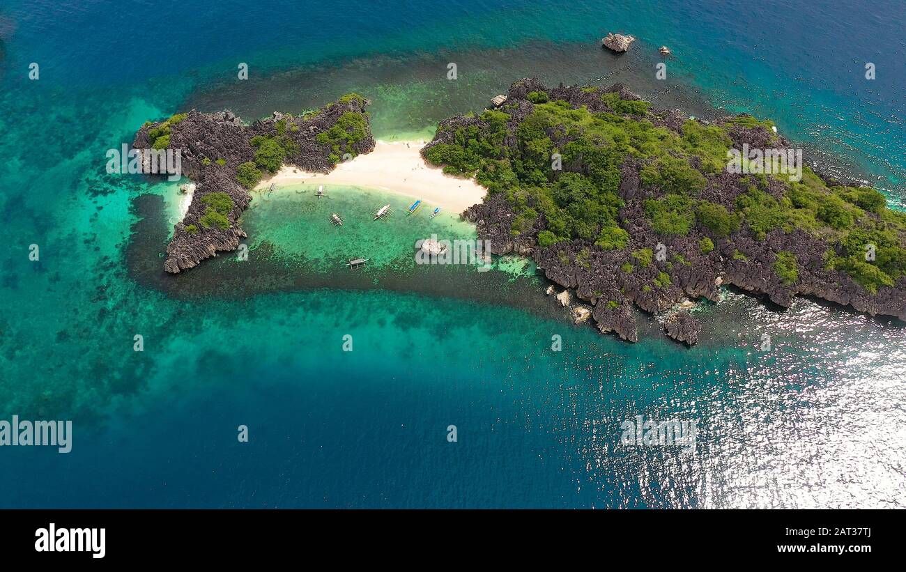 Tropical island with sandy with tourists and blue sea, aerial view ...