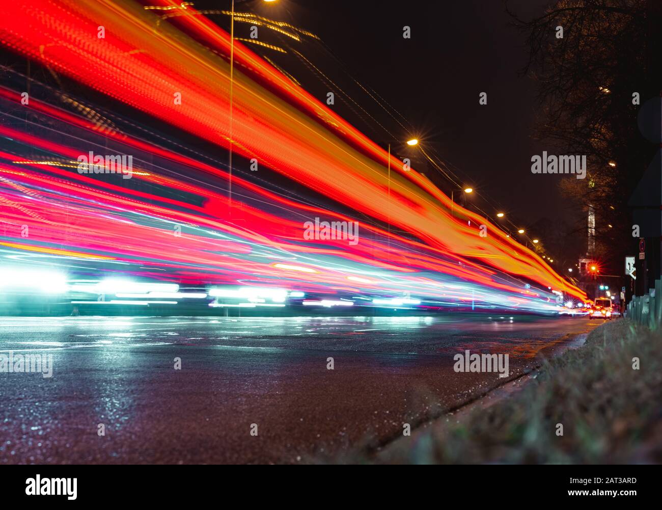 Red light trails in the illuminated highway at night Stock Photo - Alamy