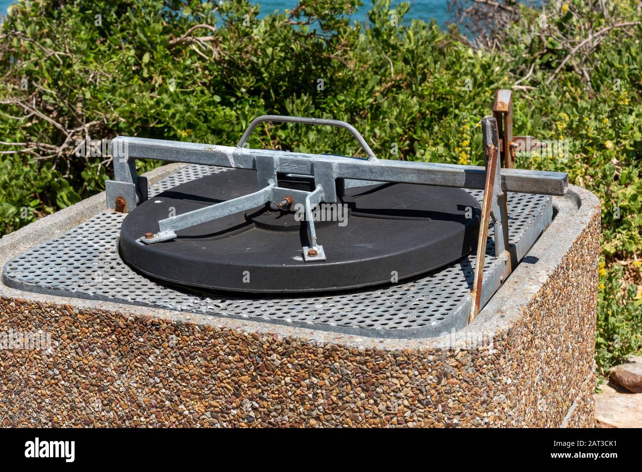 Western Cape, South Africa. Dec 2019. Roadside waste bin with a heavy ...