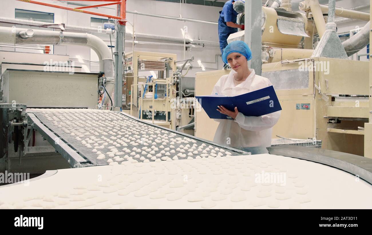 Controller checking conveyor candies hi-res stock photography and ...