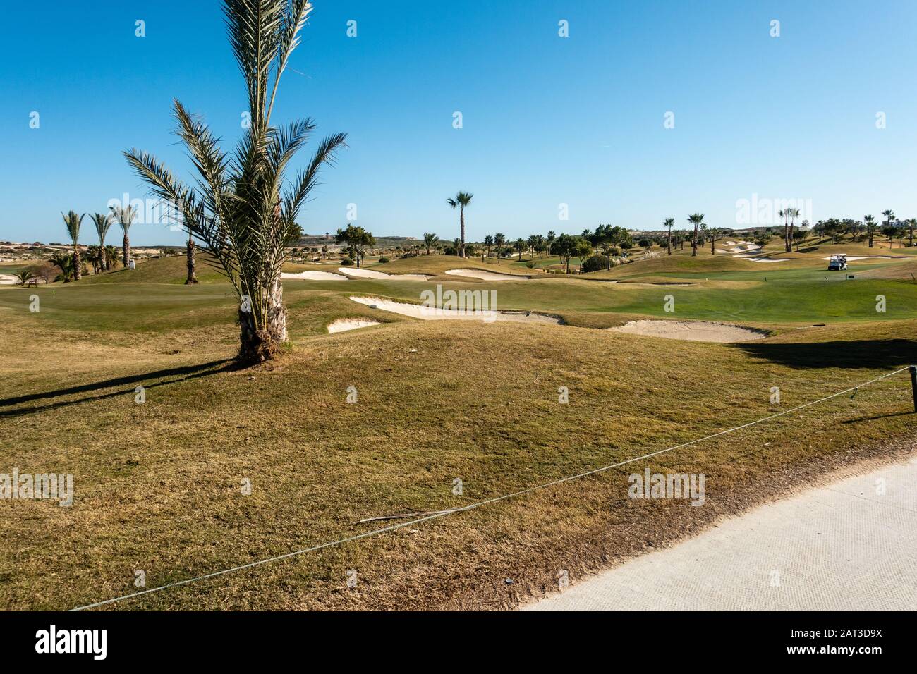 Gold course with trees and pathways under a clear blue sky in Spain ...