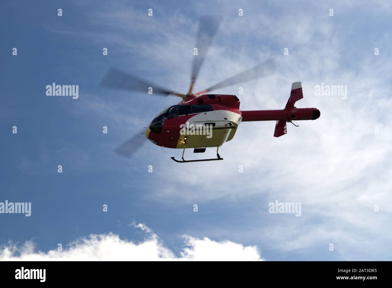 Flying helicopter from below against a blue sky Stock Photo - Alamy