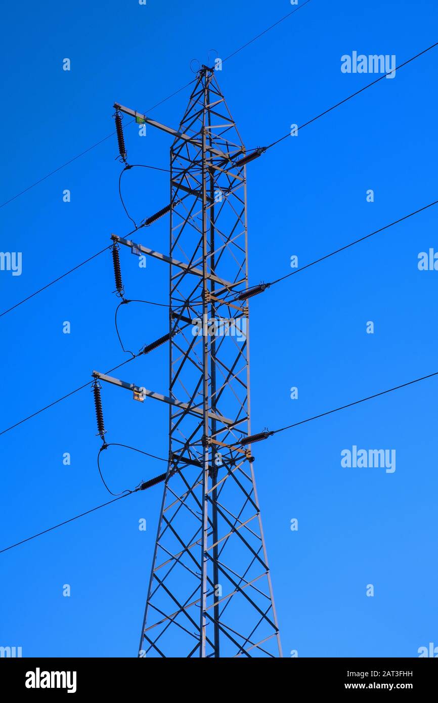 High voltage transmission line supported by the metal construction of a ...