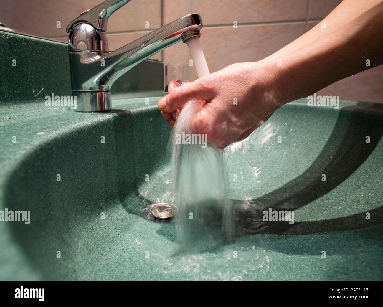 running tap water in bathroom Stock Photo - Alamy
