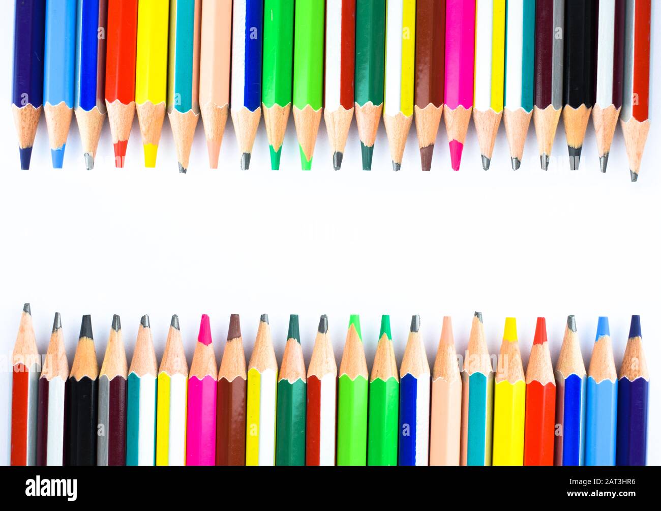 Two rows of different colored pencil wax crayons arranged together ...