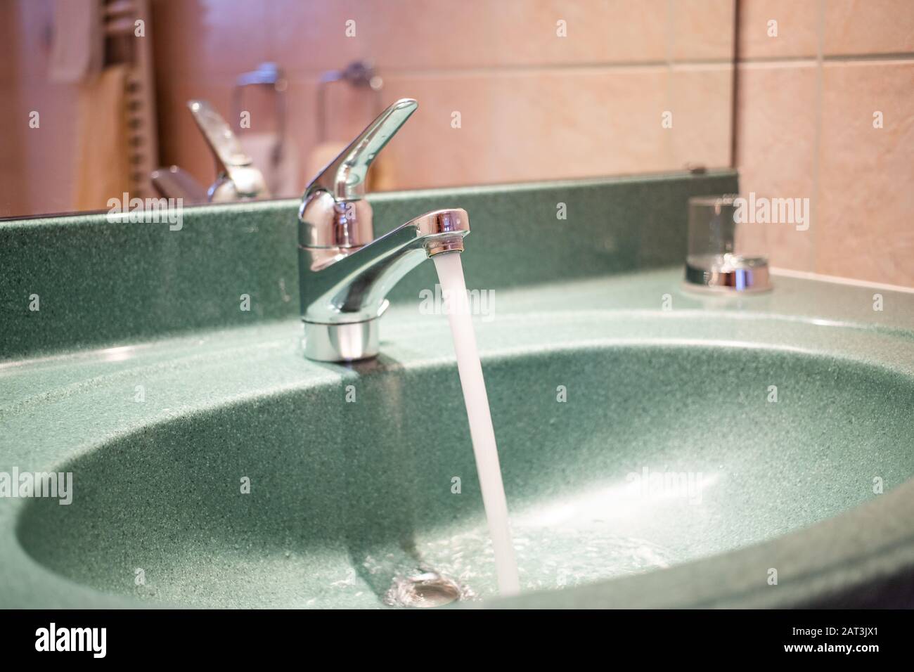 running tap water in bathroom Stock Photo - Alamy