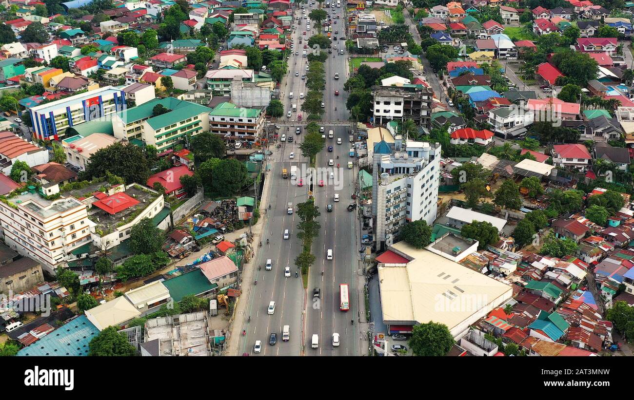 Highway with heavy traffic in Manila, aerial view. Streets and houses ...