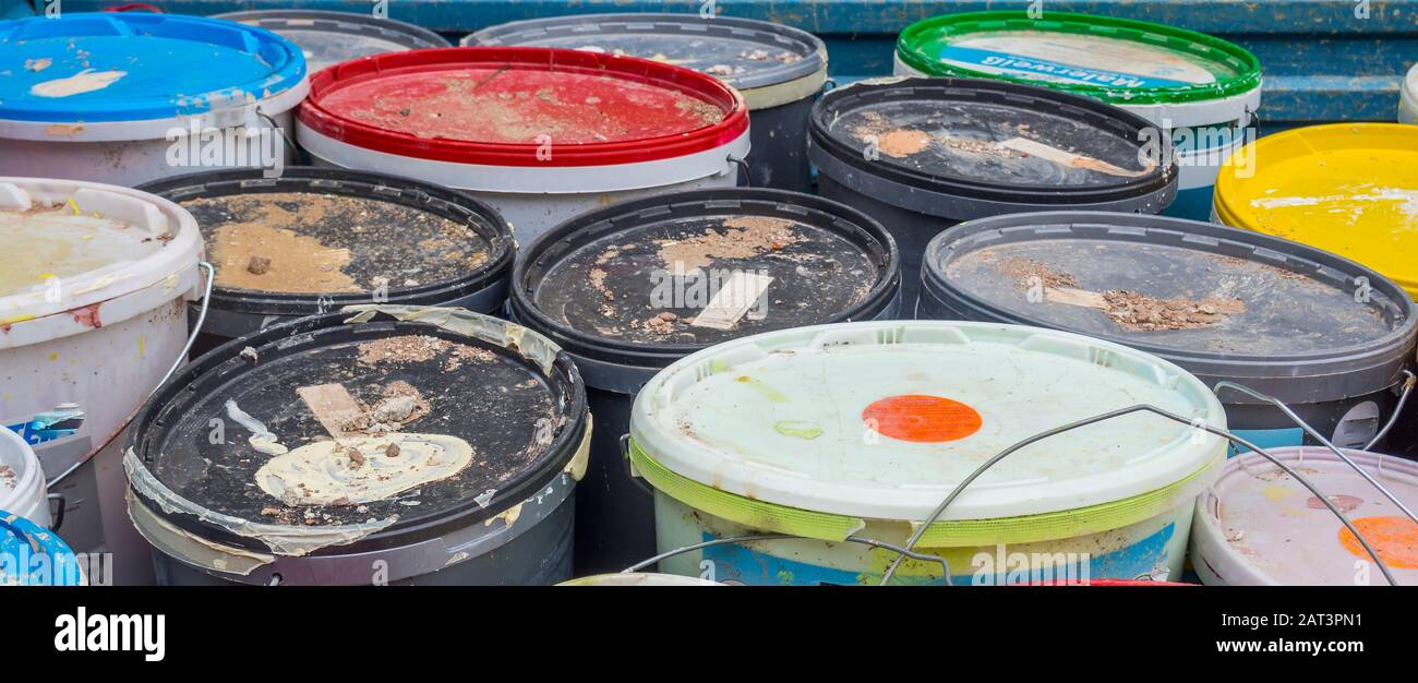 Panorama Old paint buckets on the construction site Stock Photo - Alamy