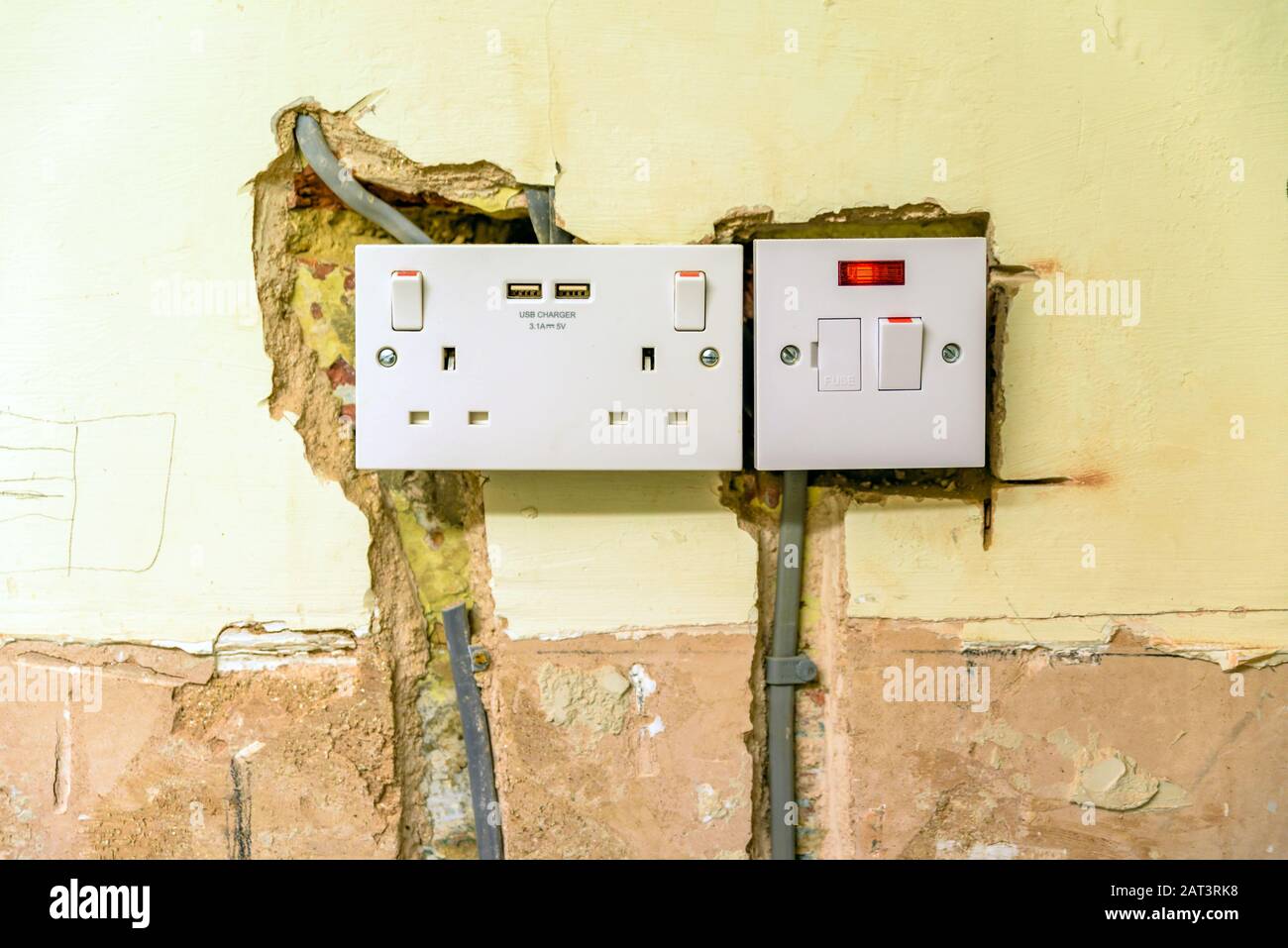 electric socket in a wall during renovation in england uk Stock Photo ...