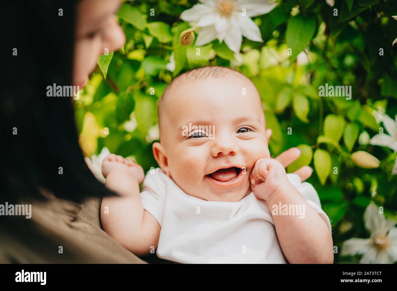 Beautiful portrait of little baby boy on flowers bush background. Child ...