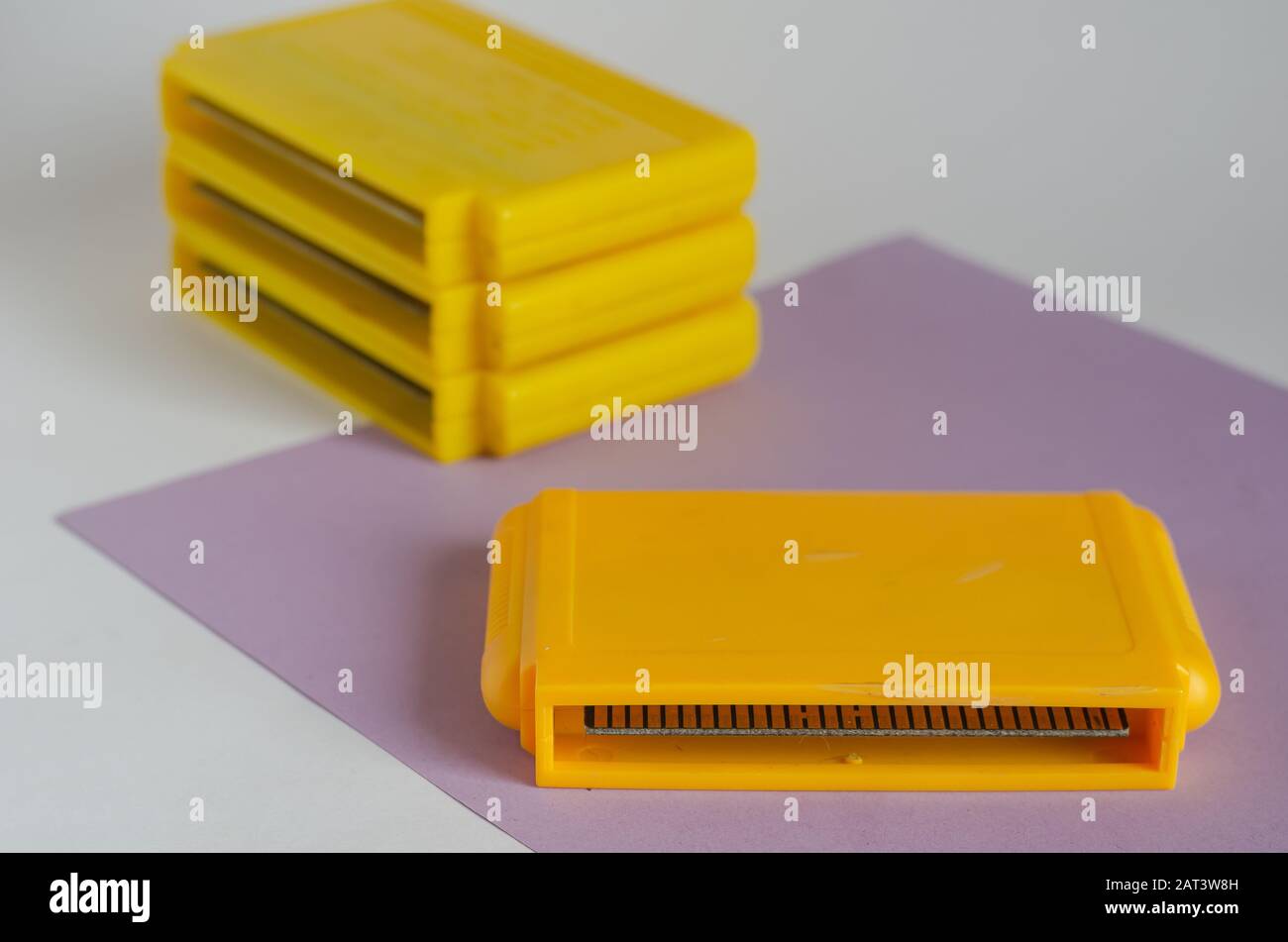 A set of game cartridges with TV games. Four yellow cartridges with ...