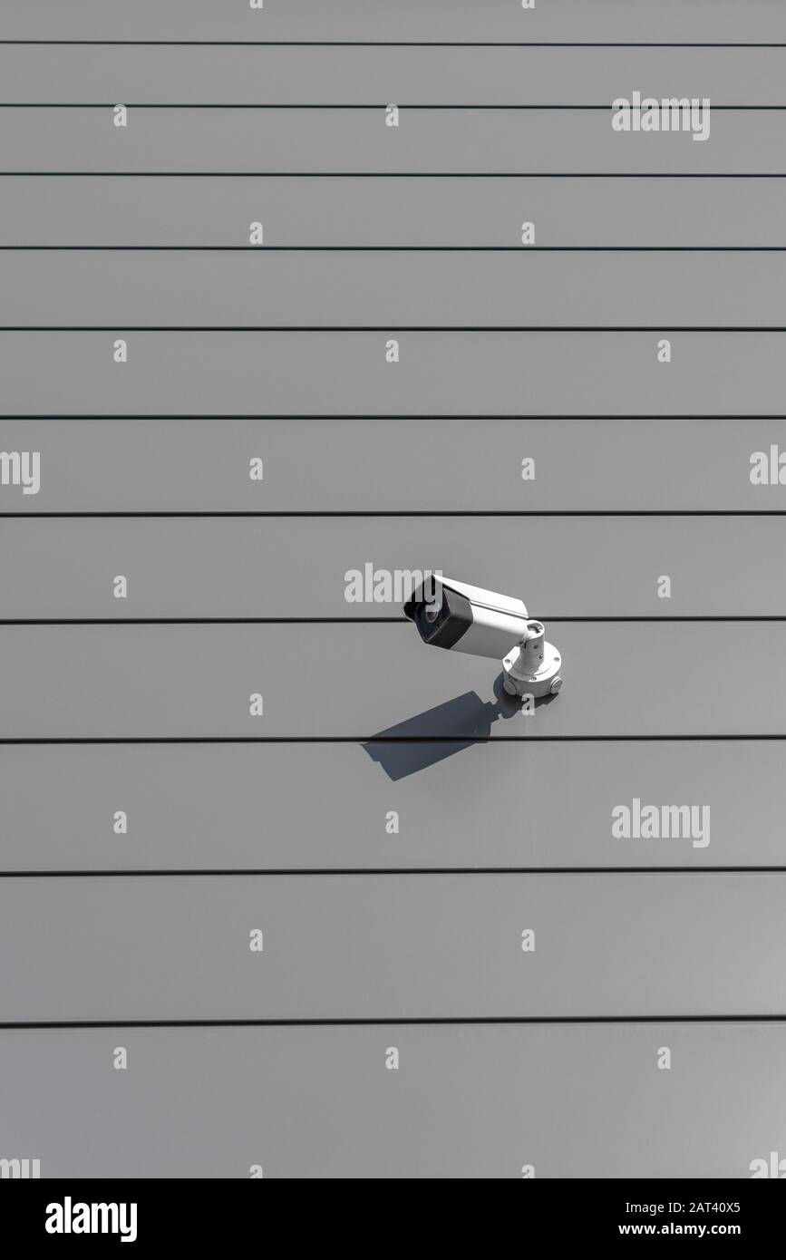 CCTV Security camera on building wall geometric linear grey sunny ...