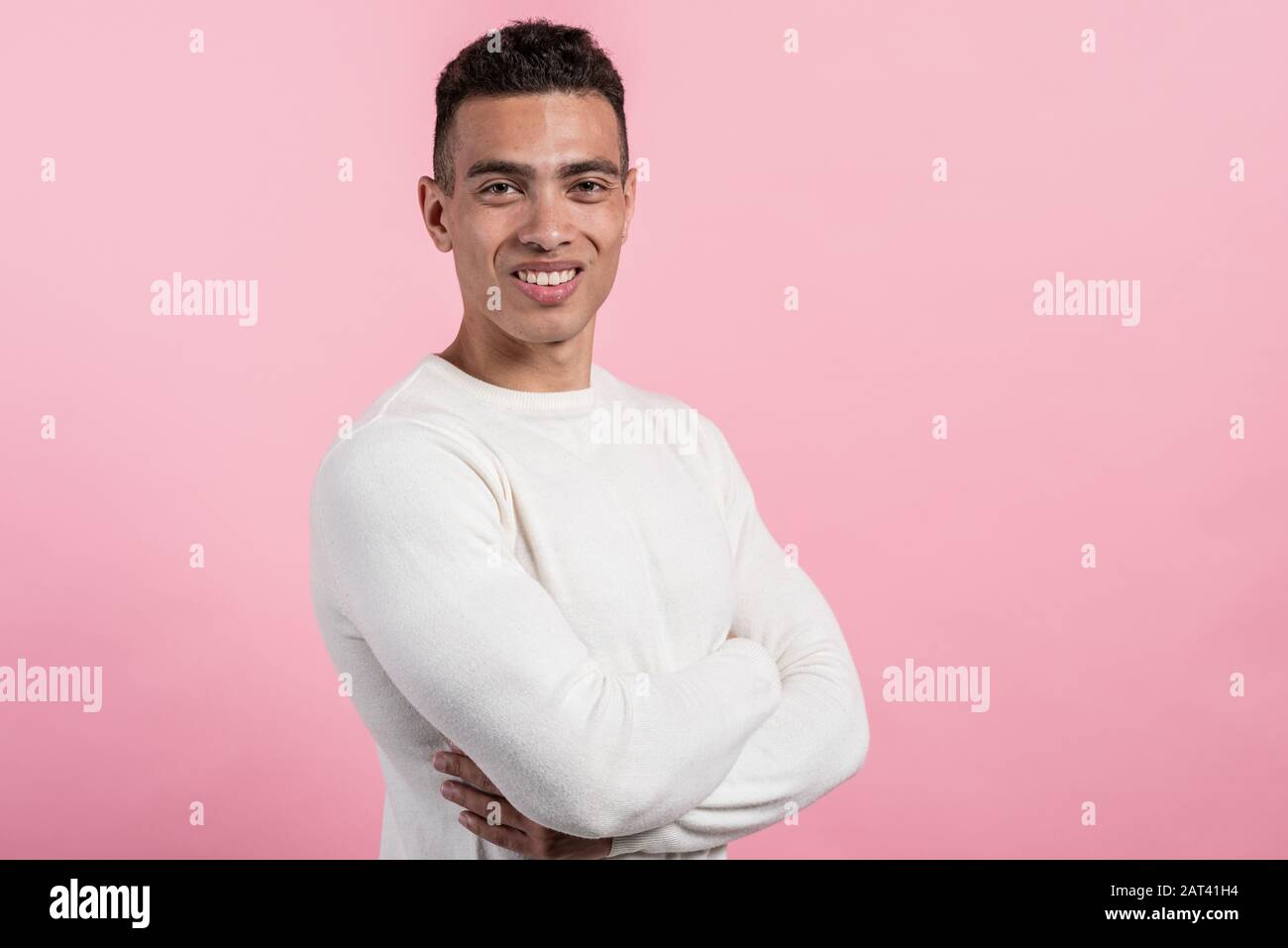 Closeup half-turn portrait of happy mulatto man posing in the studio ...