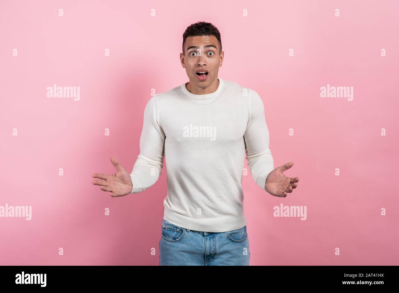 Wonder emotional man on pink studio background. Male half-length ...