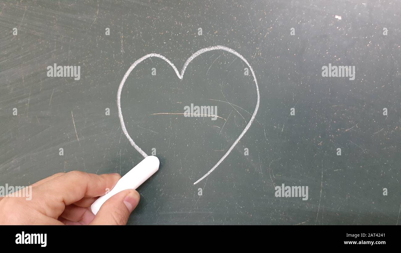 love hearts drawing on a school chalkboard, hand Stock Photo - Alamy