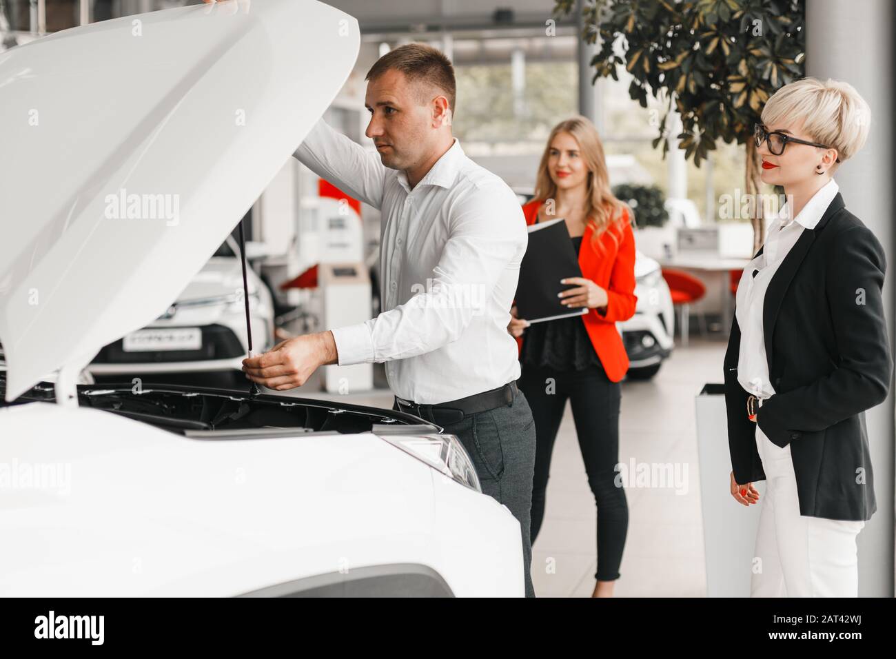 Woman opening car hood looking hi-res stock photography and images - Alamy