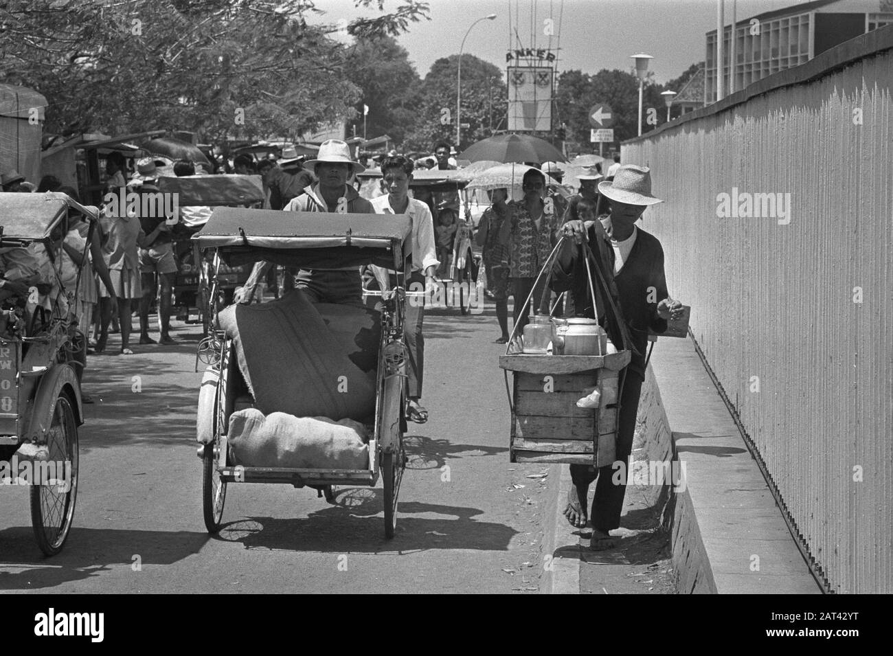 Indonesia, Jakarta, Rickshaw and man with baskets at street Date: 20 ...