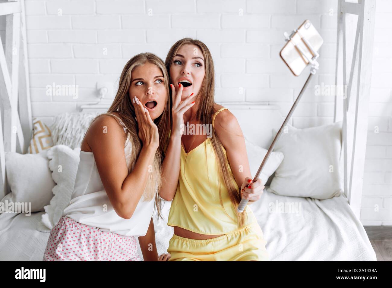 Surprised girls take selfies Stock Photo - Alamy