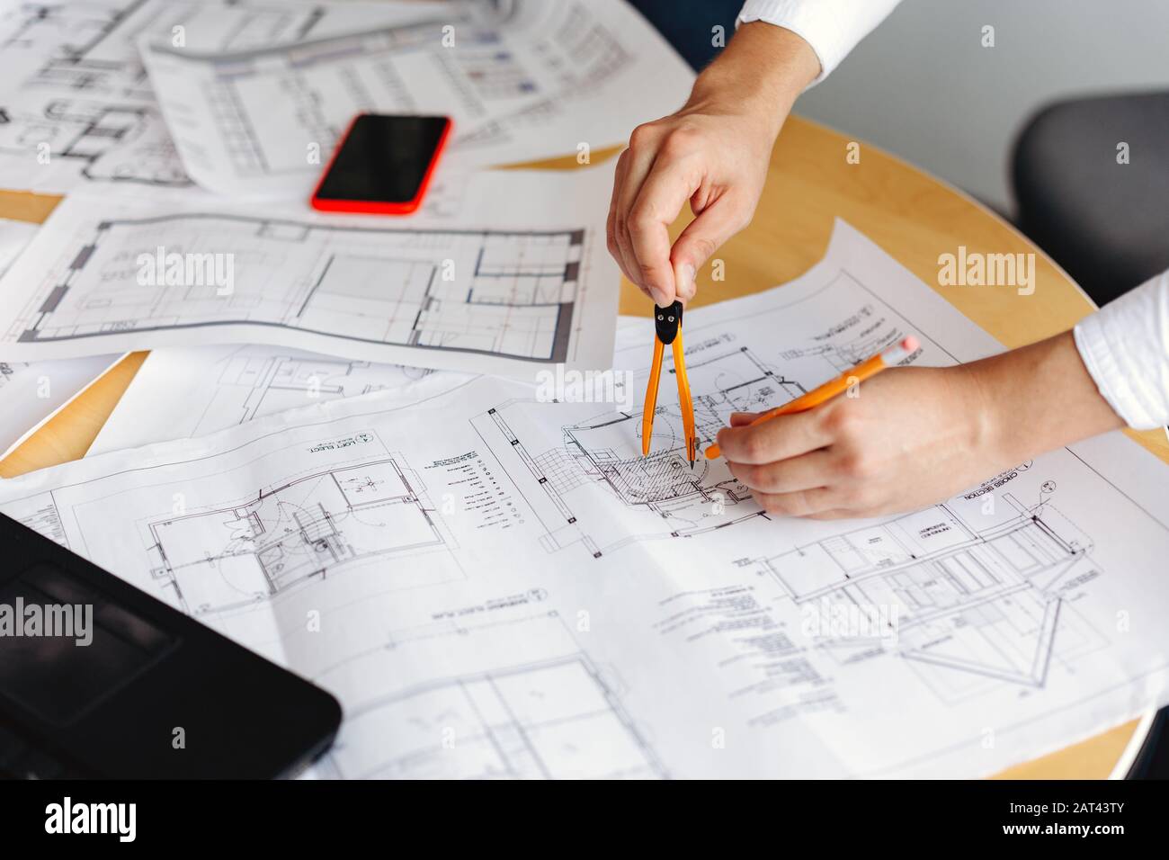Male architect drawing blueprints in office workplace Stock Photo - Alamy