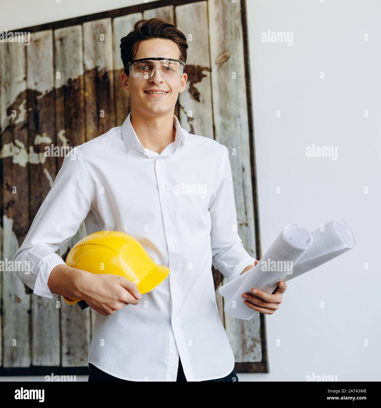 Professional builder in a helmet with drawings, construction company ...