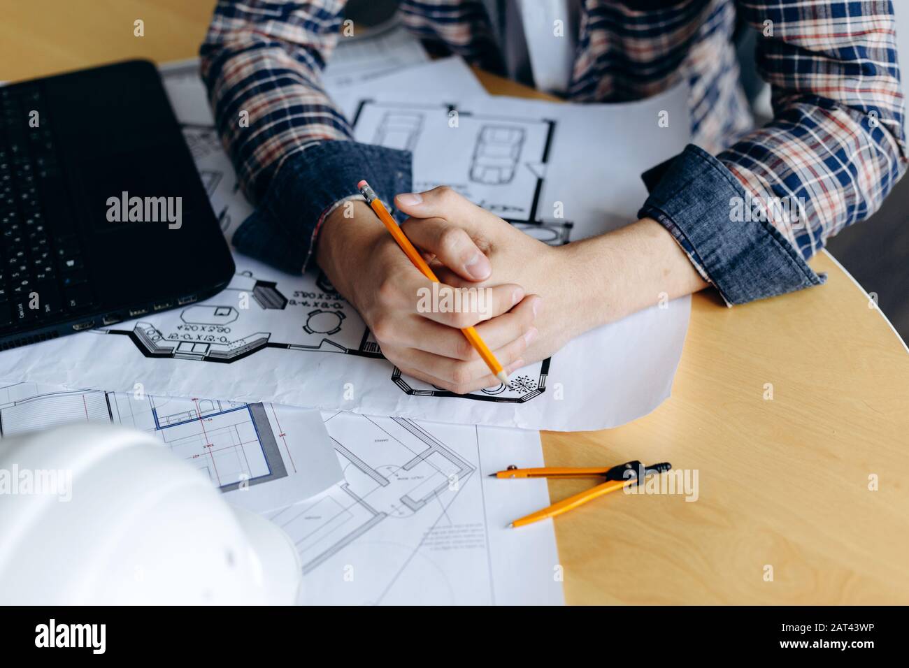 Young creative male engineer working with new project on drawing Stock ...