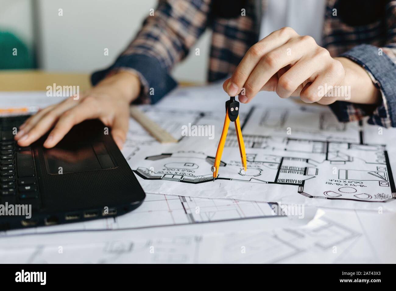 The engineer measures the compass of the drawing Stock Photo - Alamy
