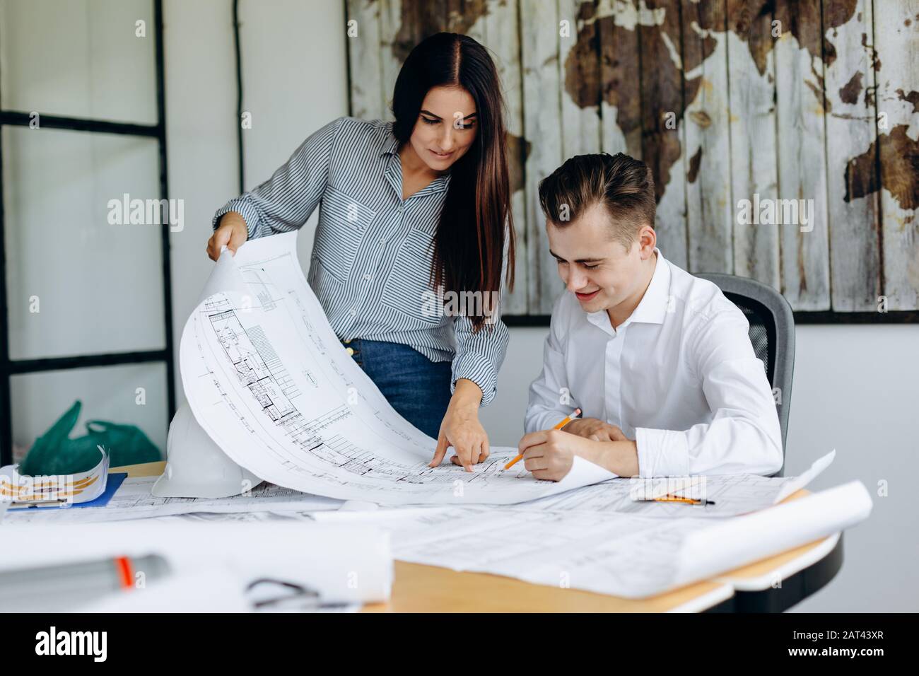 Two professional architects are working on the drawing Stock Photo - Alamy