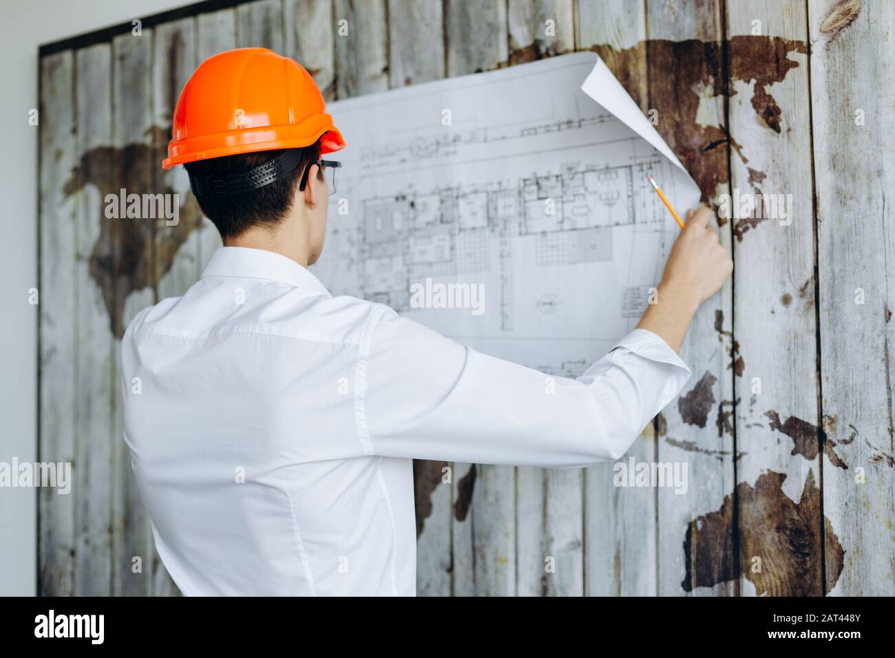 Young man with his back looking at the plan Stock Photo - Alamy