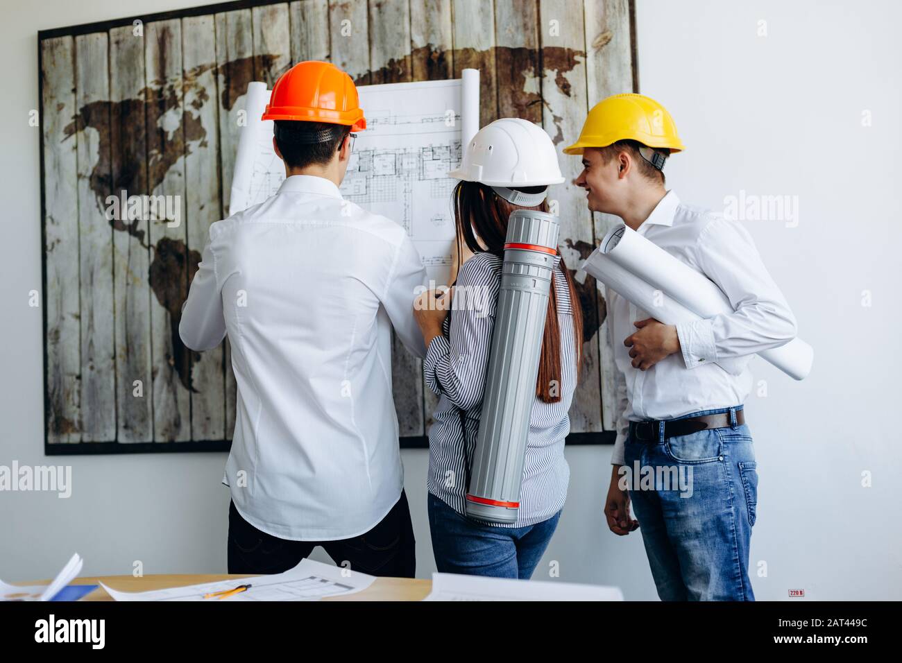 Professional team of architects, back turned and evaluate the outlined ...