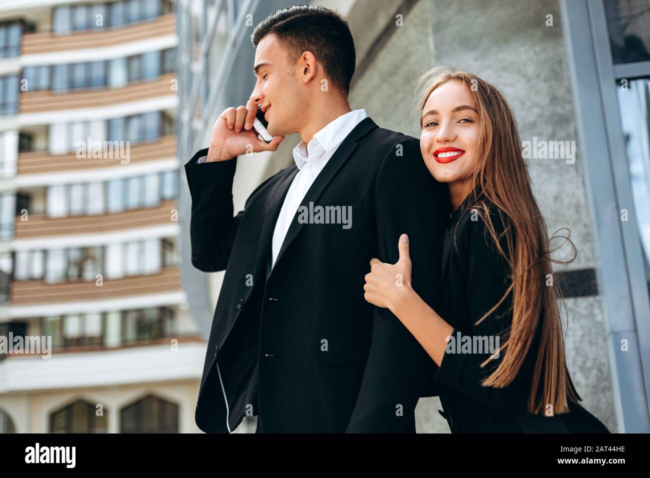 Closeup portrair woman hugging a man who talking a mobile phone.- Image ...