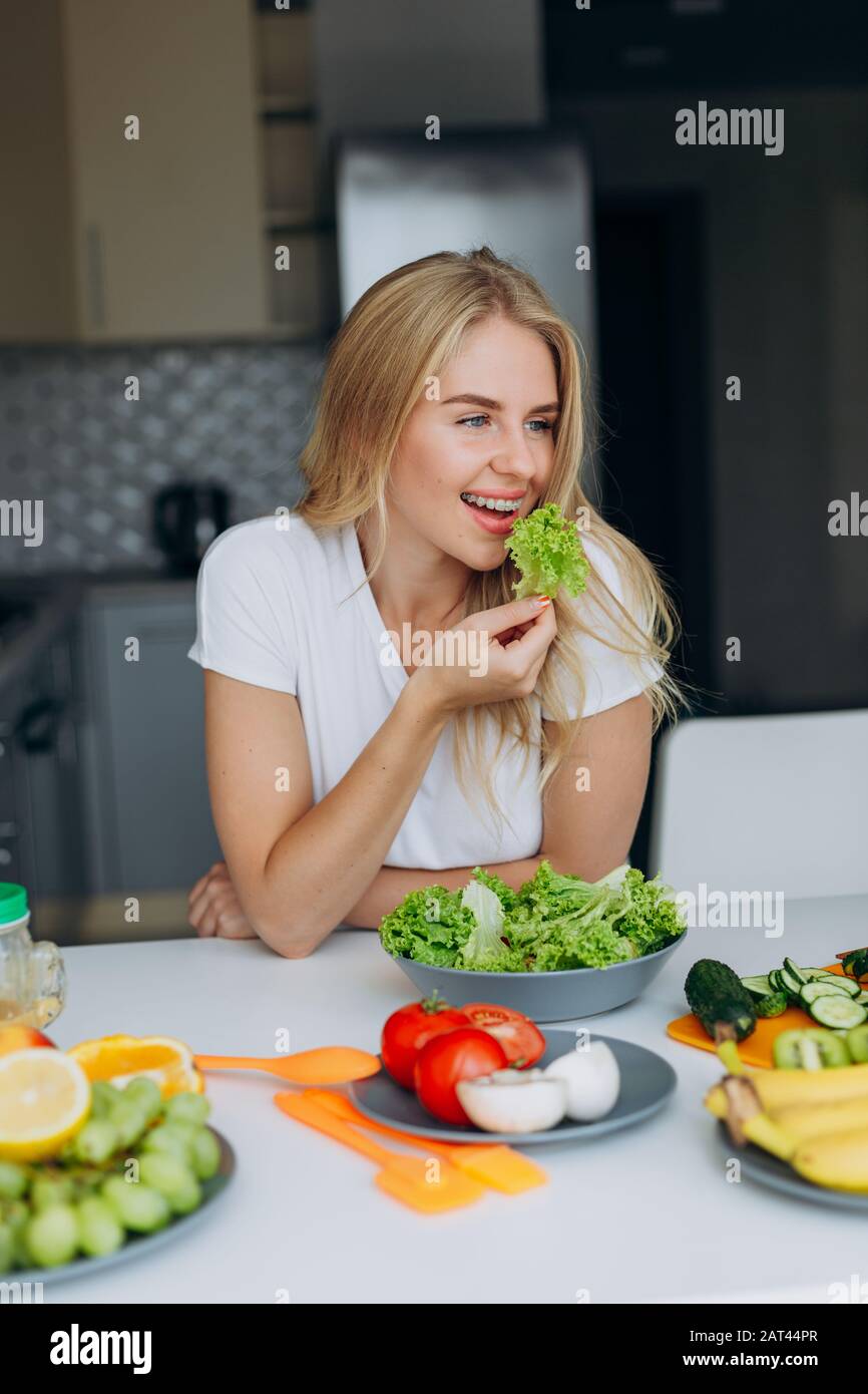 Portrait of happy woman at the table eating a healthy food. - Image ...