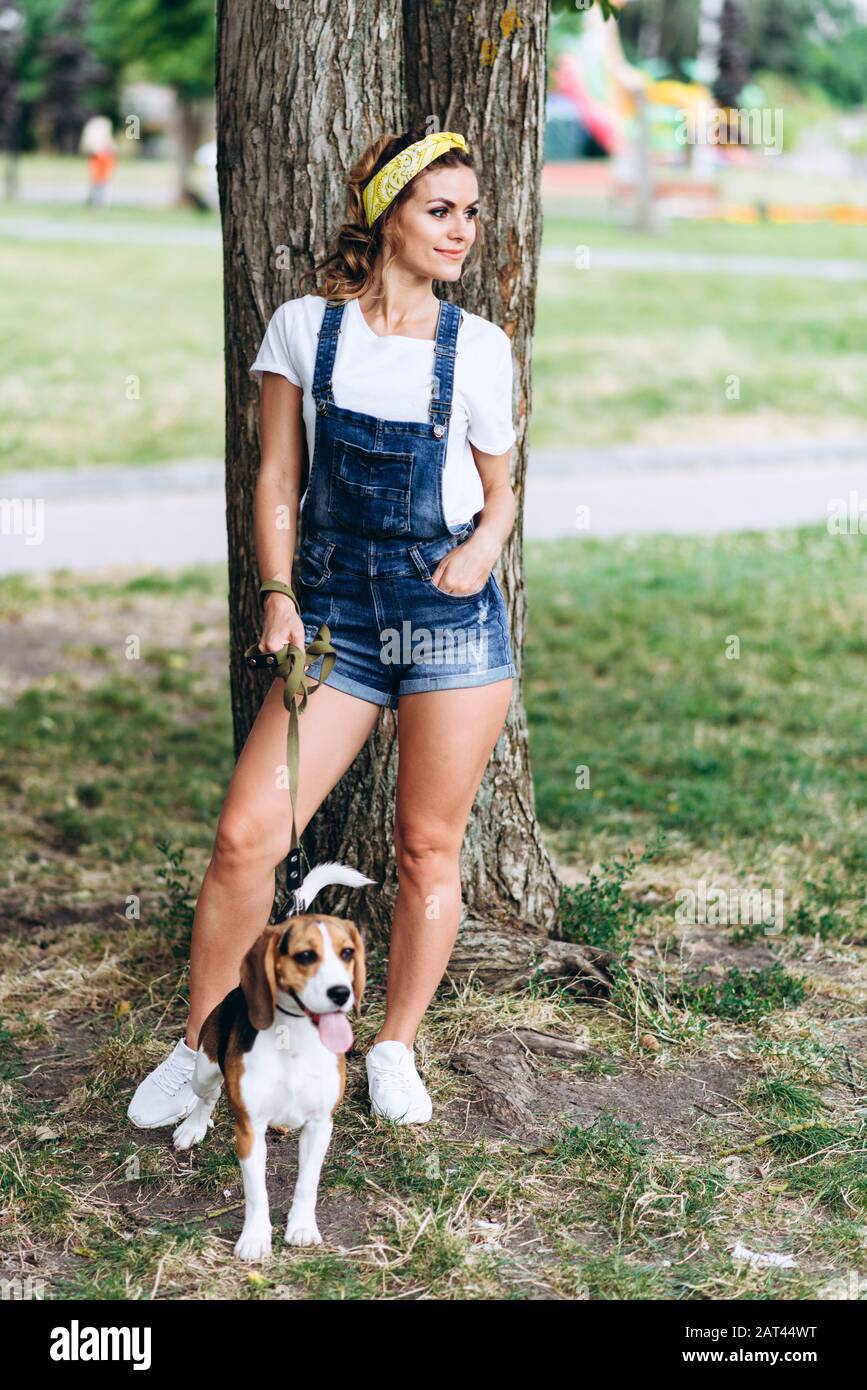 Woman standing with a dog outdoor . - Image Stock Photo - Alamy