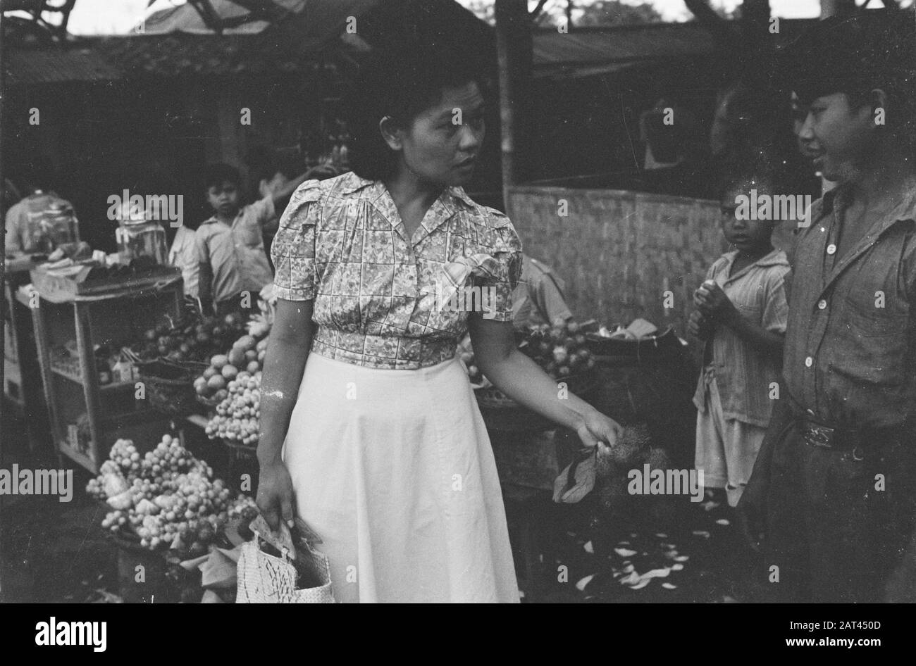 Indonesian woman in european clothing on the market Date: april 1947 ...