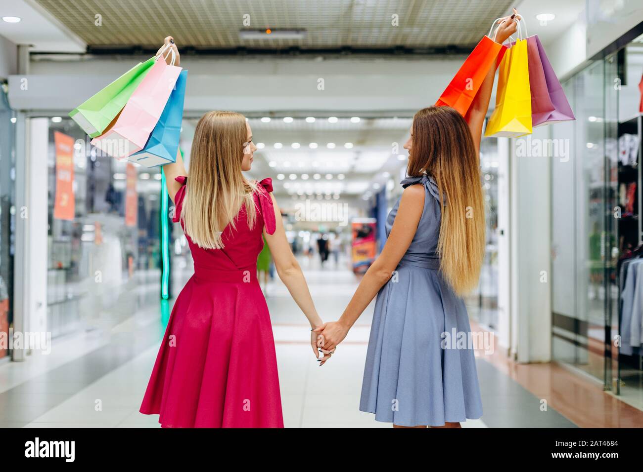 Beautiful girls walking around the mall after shopping Stock Photo - Alamy