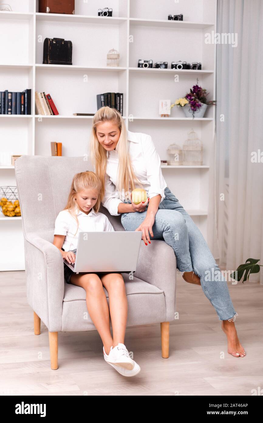 Mother and daughter work at home at the computer Stock Photo - Alamy