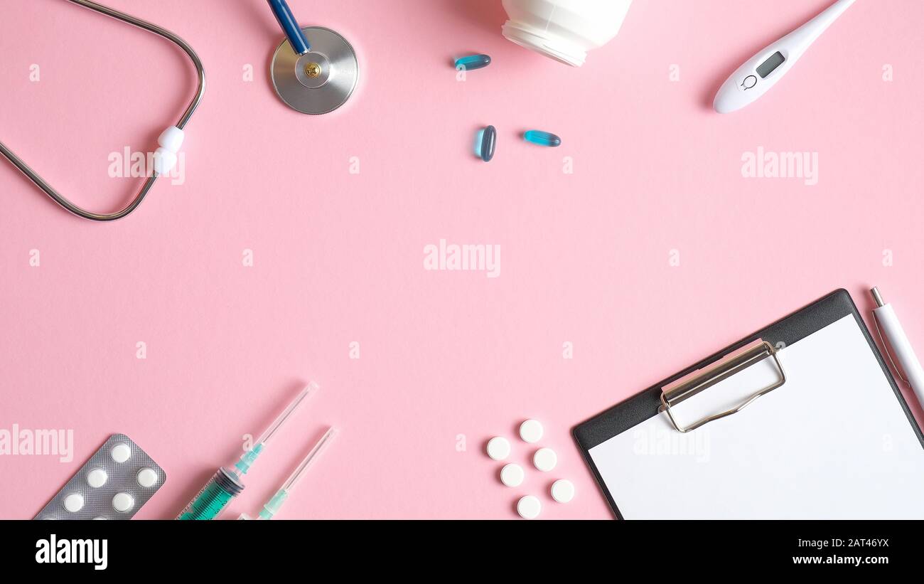 Medical equipment on pink background. Top view doctors table desk with ...