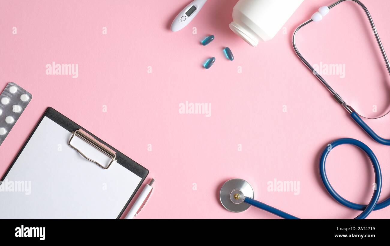 Medical equipment on pink background. Top view doctors table desk with ...